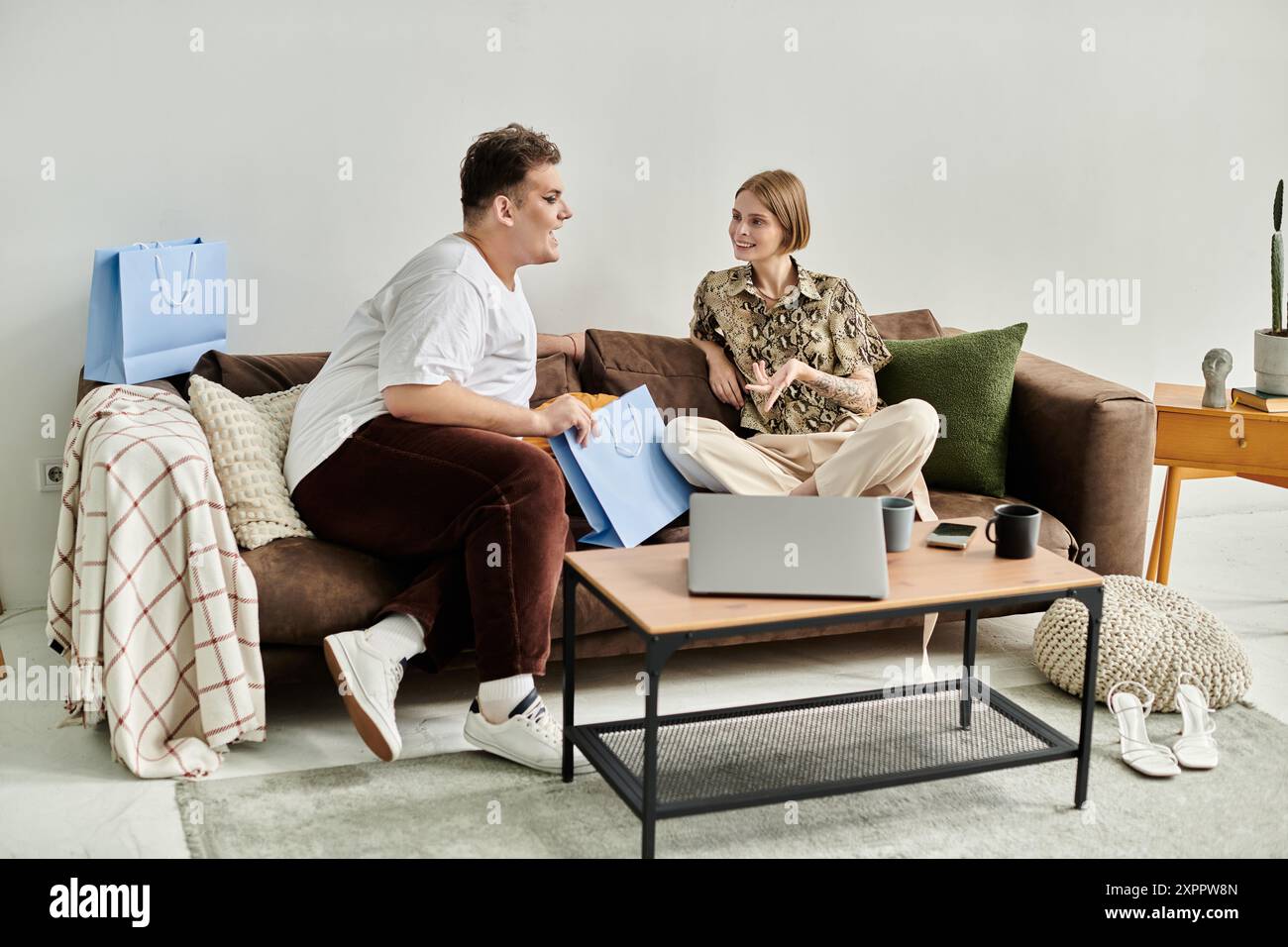 Two friends share laughter and conversation in a stylish living room ...