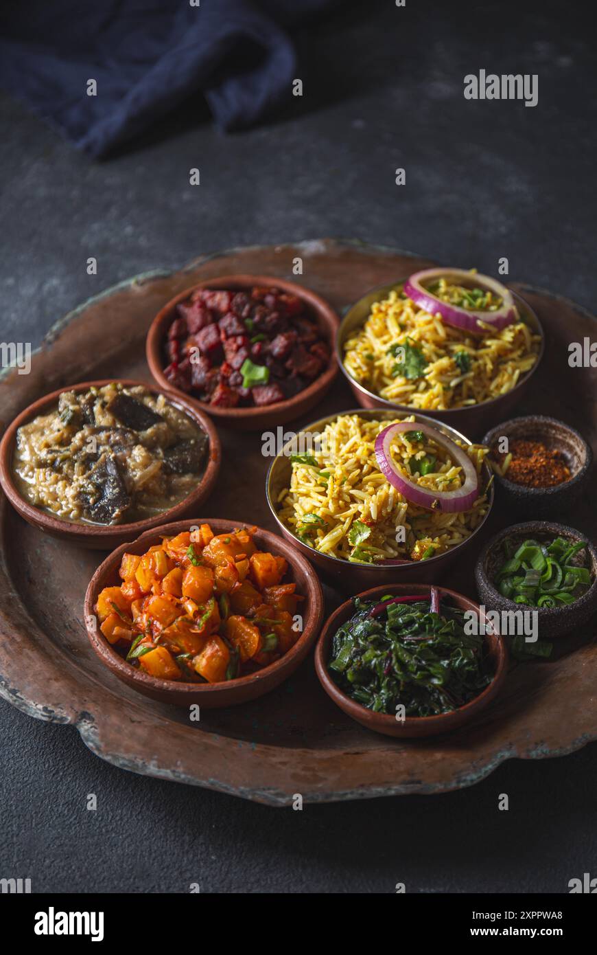 A plate featuring rice biryani and a variety of vegetarian Indian and ...