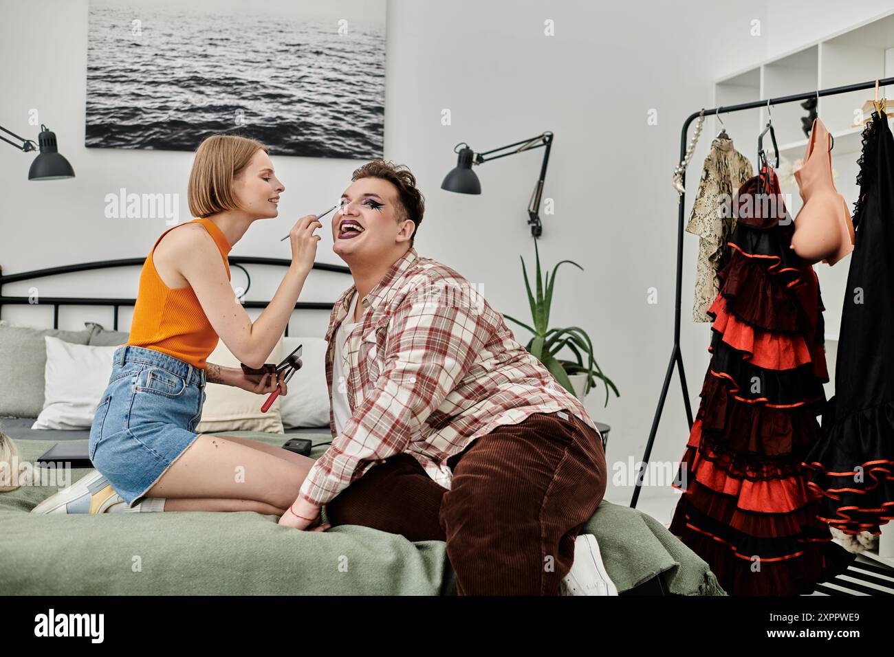 Two friends share a playful makeup moment in a cozy indoor setting ...