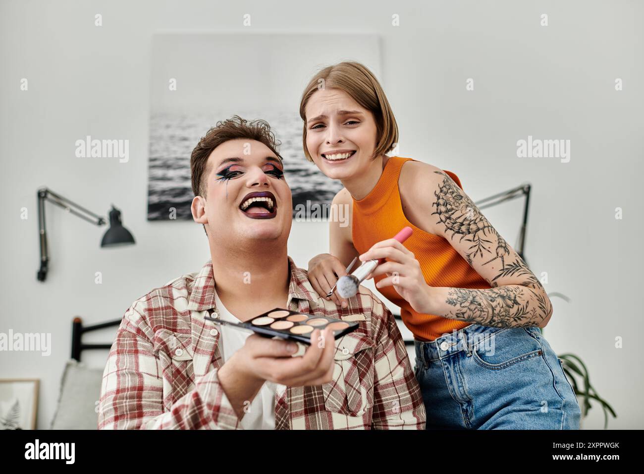 Two friends share a joyful makeup moment in a cozy home setting Stock ...