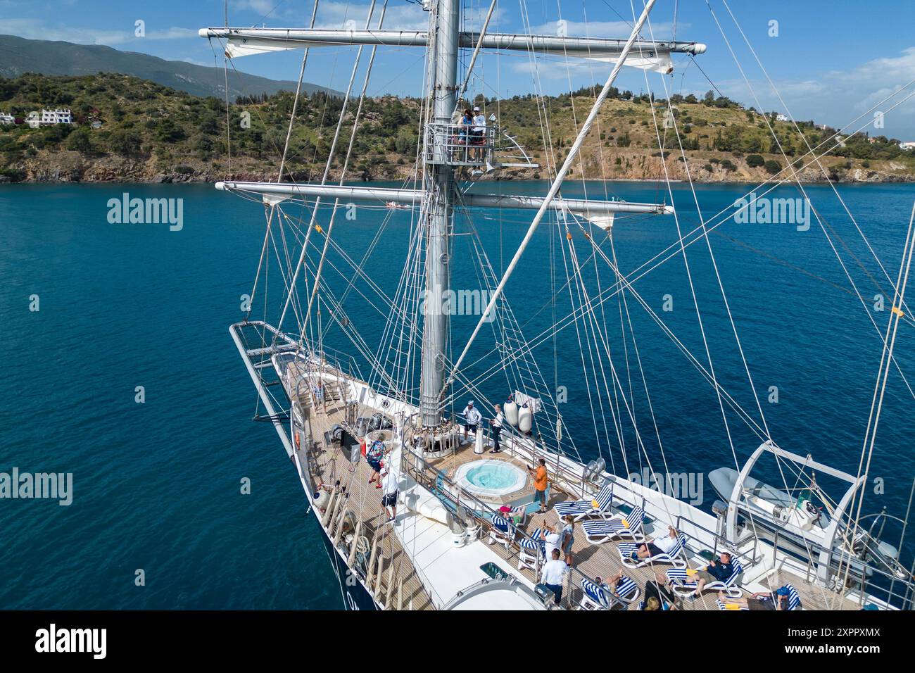Aerial view of passengers climbing the mast on board the sailing cruise ...