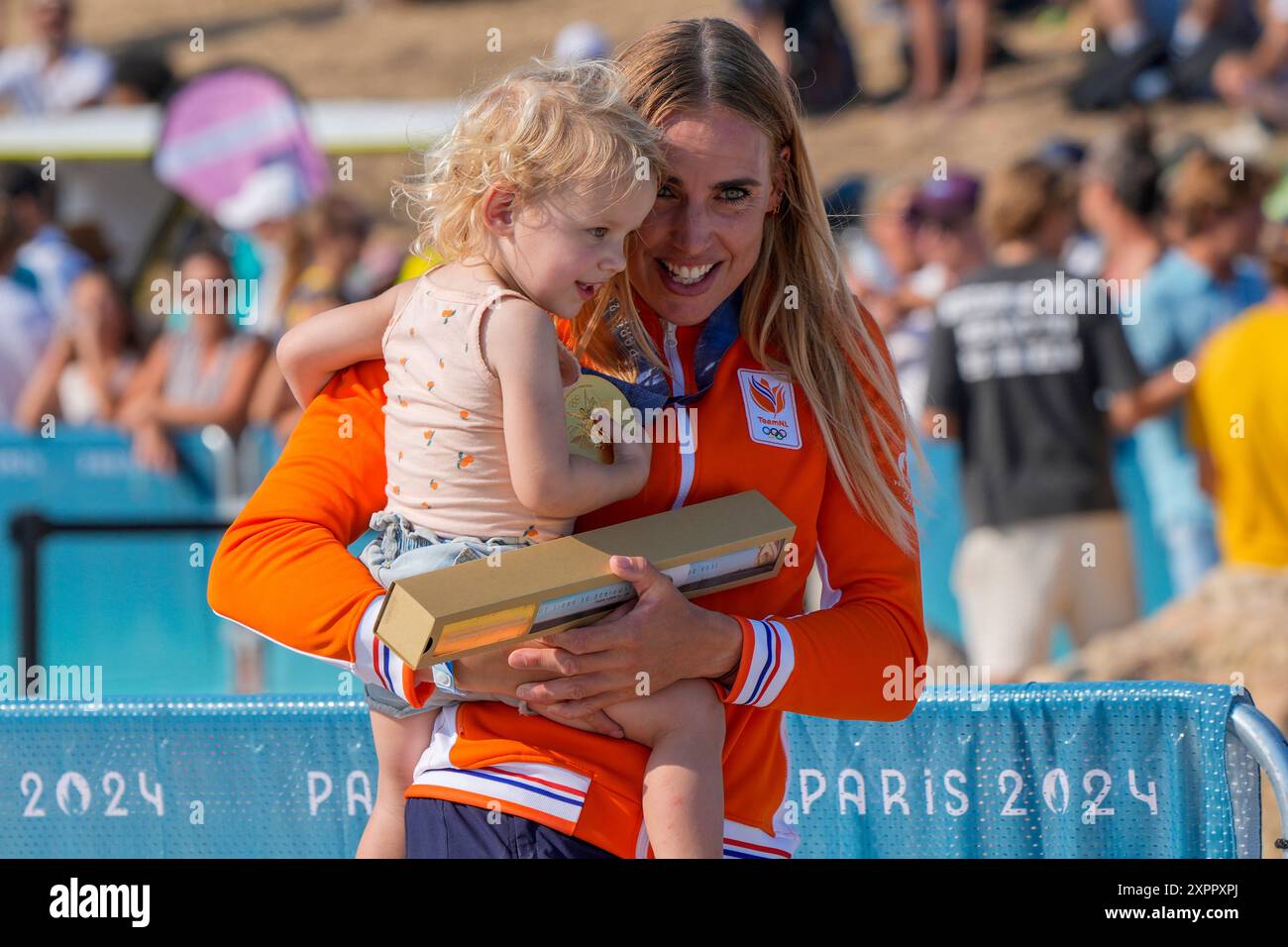 Marit Bouwmeester of the Netherlands holds her daughter and gold medal ...