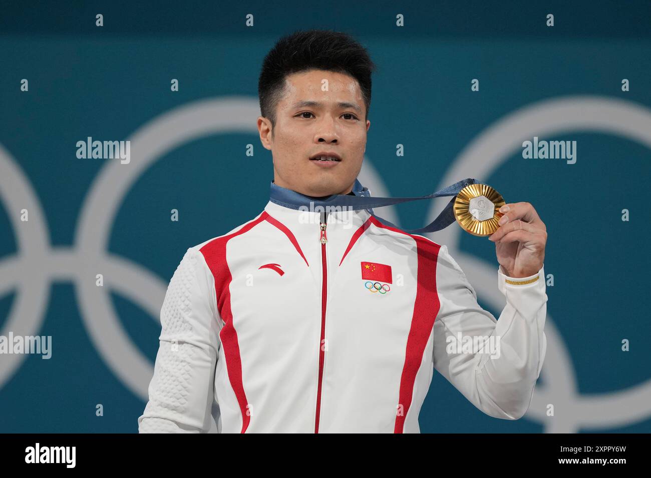 Gold medalist Li Fabin of China celebrates on the podium during the ...