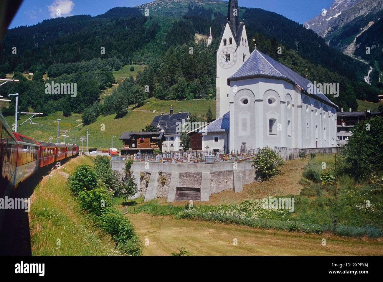 The Glacier Express train passing The Catholic parish church of St ...