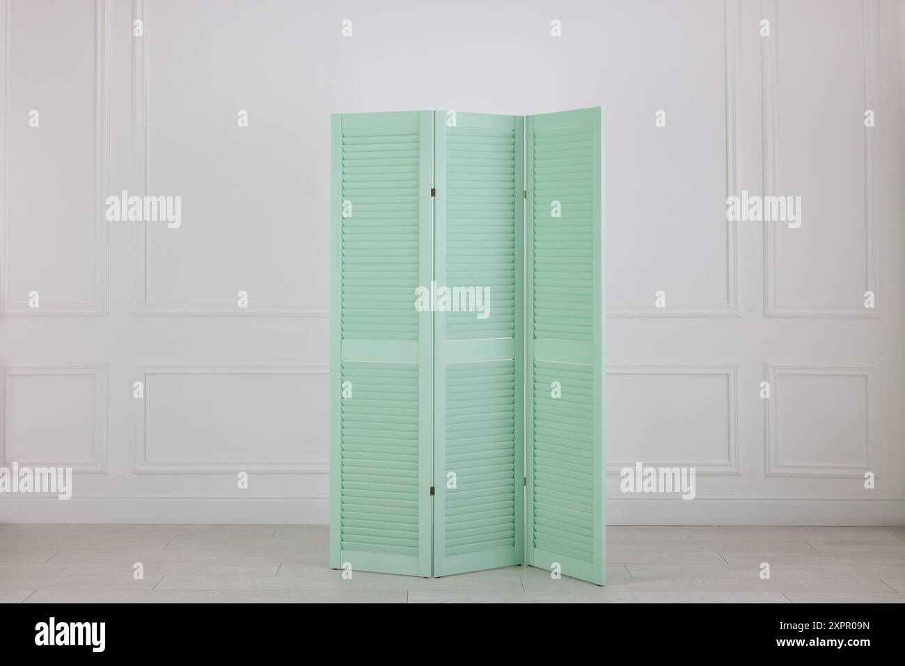 One folding screen near white wall indoors. Interior element Stock ...