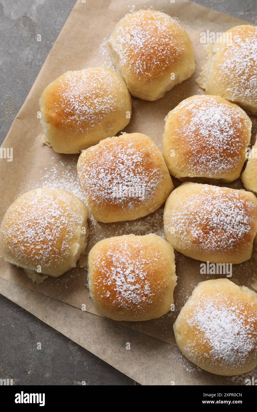 Delicious dough balls with powdered sugar on grey table, top view Stock ...
