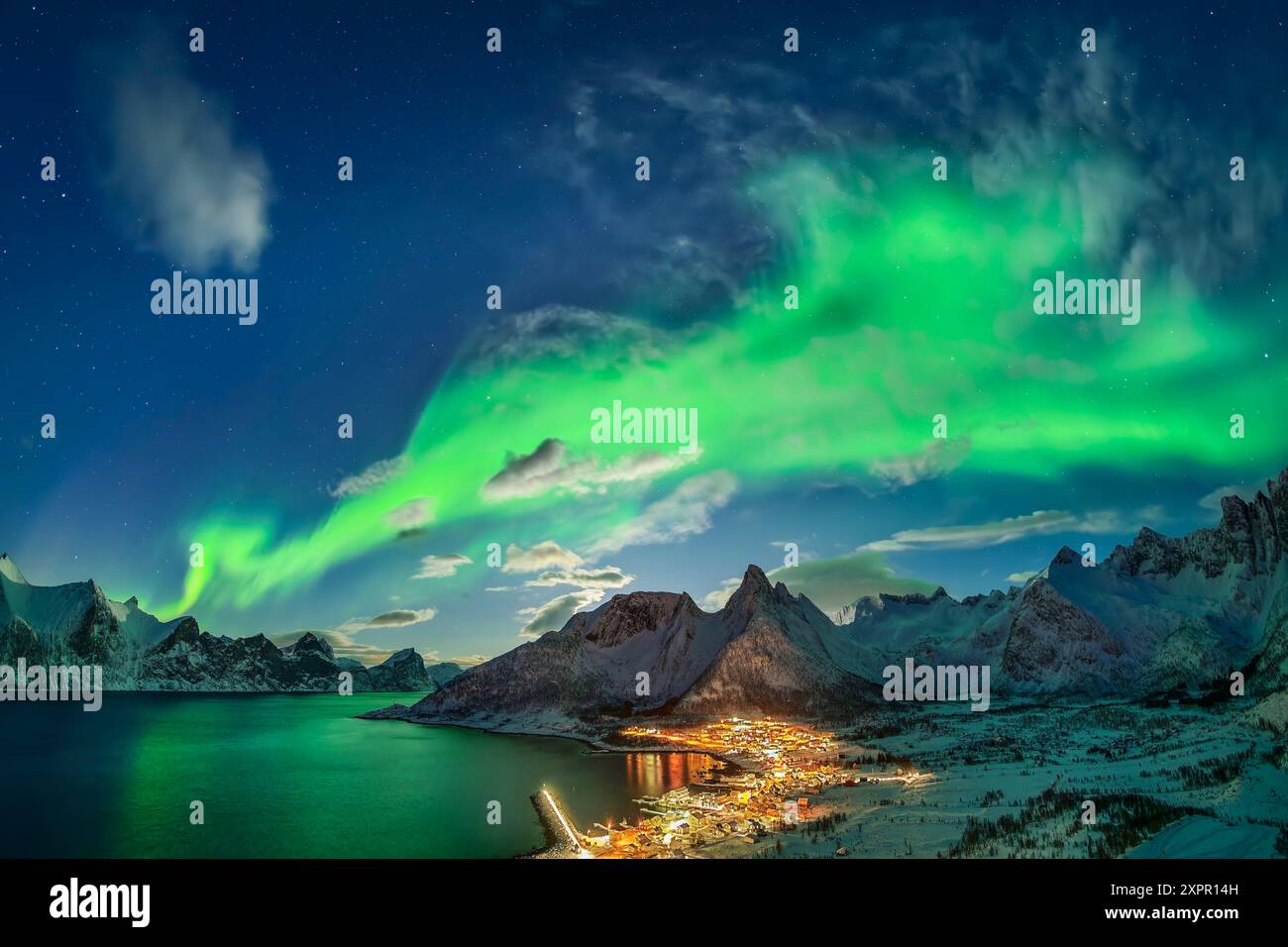 Northern lights over the illuminated village of Mefjordvaer at Mefjord ...