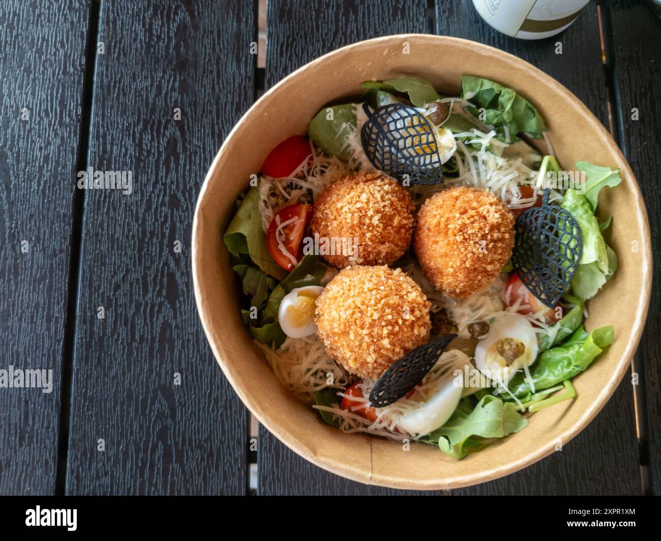 Lunch box with deep-fried meatballs and salad with arugula and salmon ...
