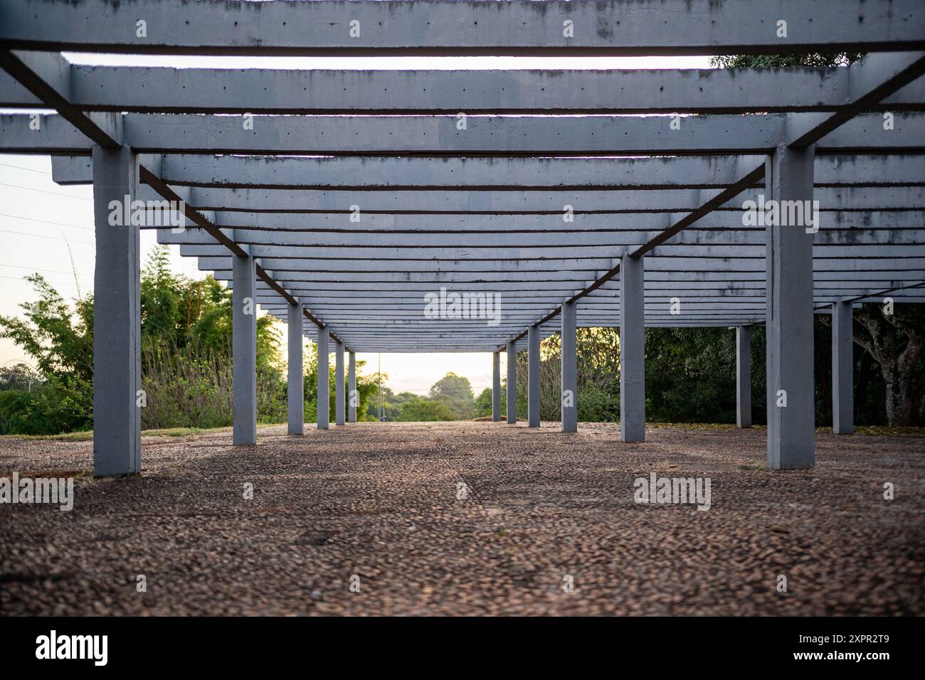 A concrete structure with a pathway leading to a green landscape in the ...