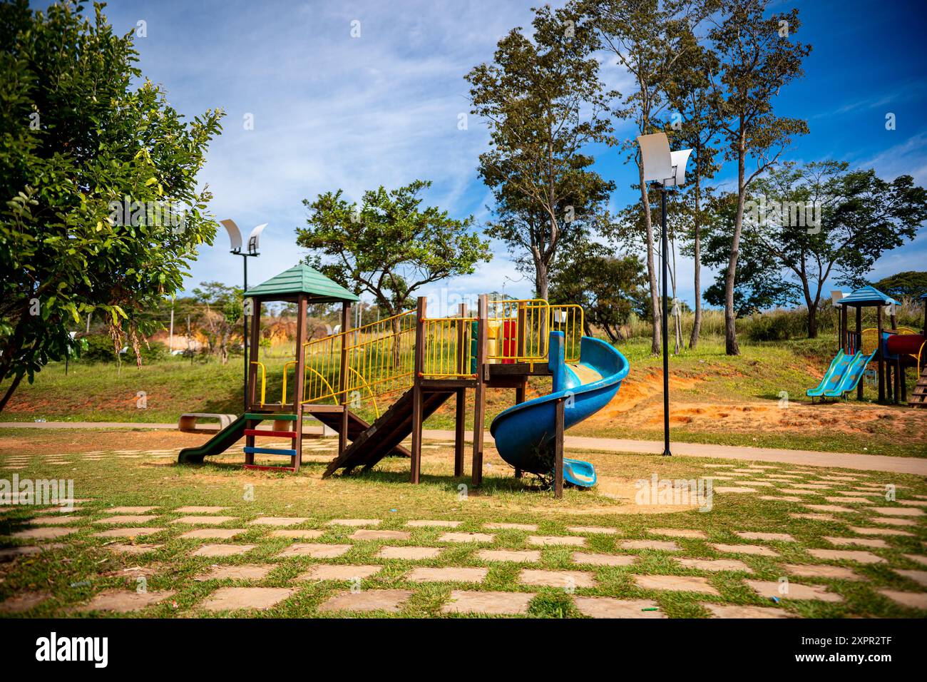 A colorful playground with slides and climbing structures in a park on ...