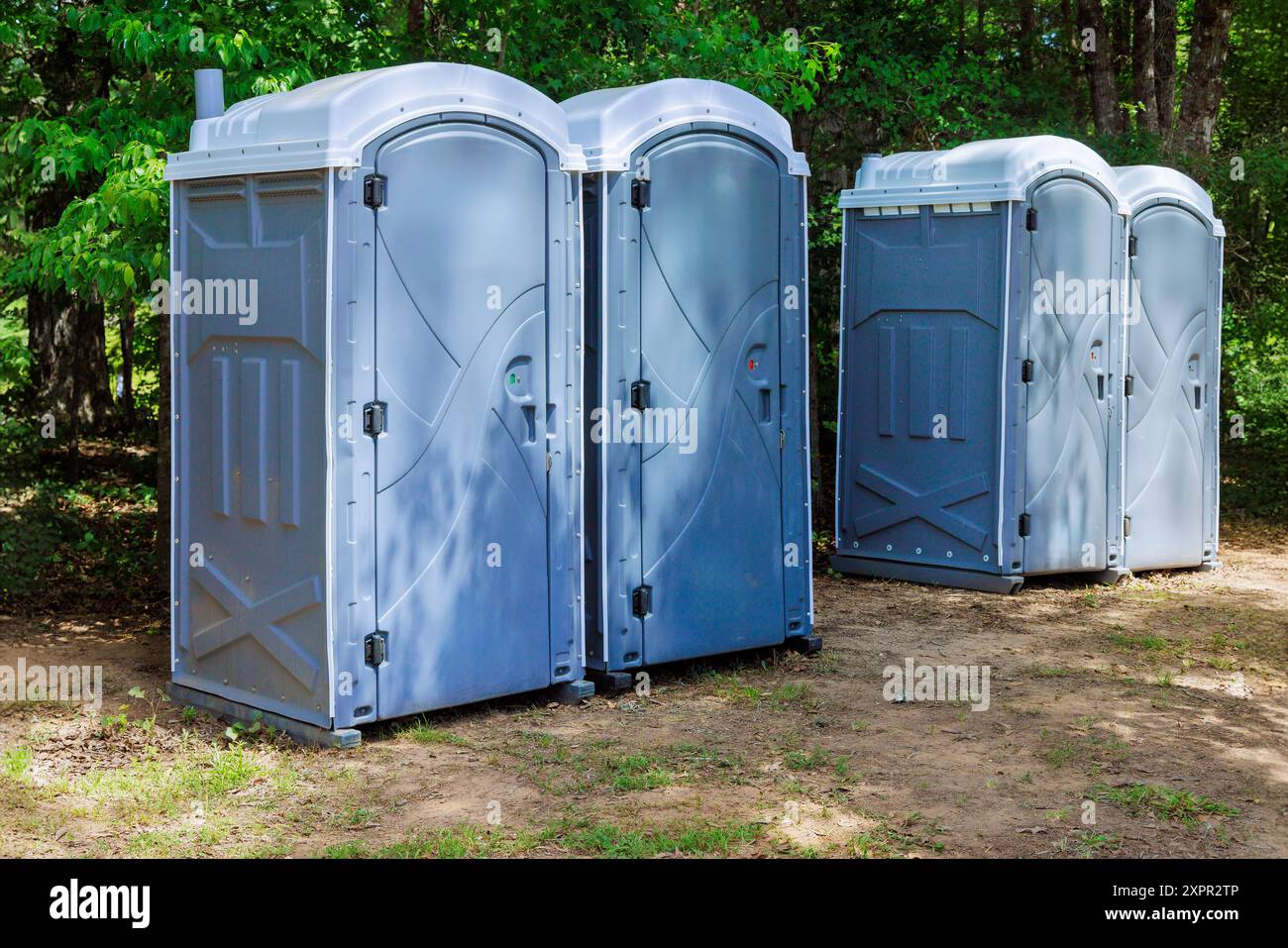 Long row portable bio of chemical toilets cabins in park center at city ...
