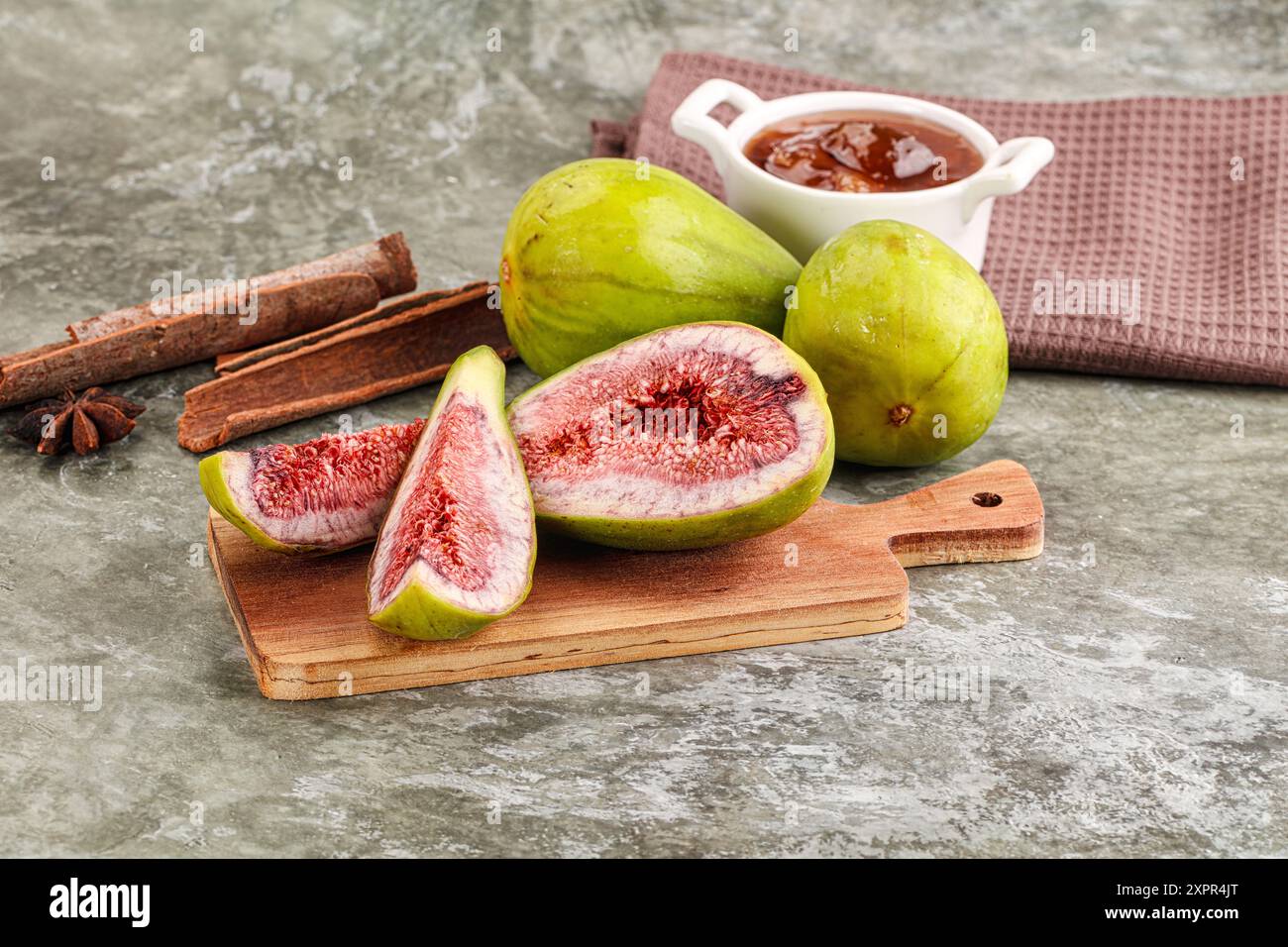 Tropical exotic green fig with cut over board Stock Photo - Alamy