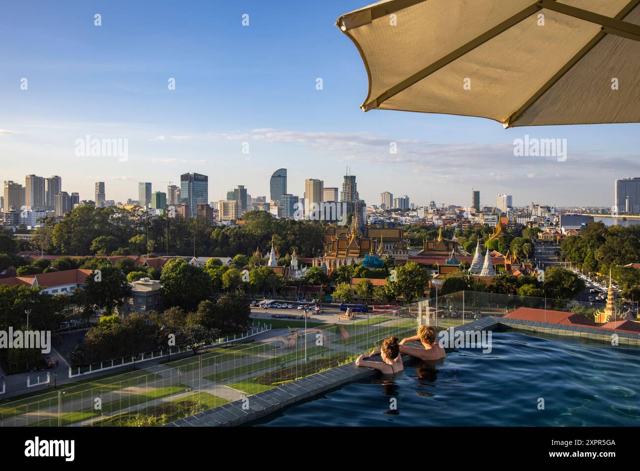 Couple in the rooftop infinity pool of Glow Park Hotel overlooking the ...