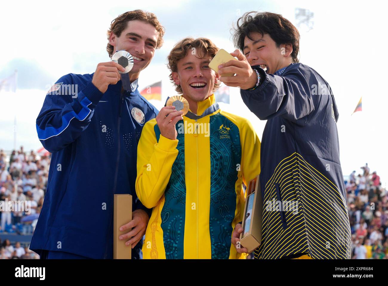 Gold medalist Australia's Keegan Palmer, center, poses on the podium ...