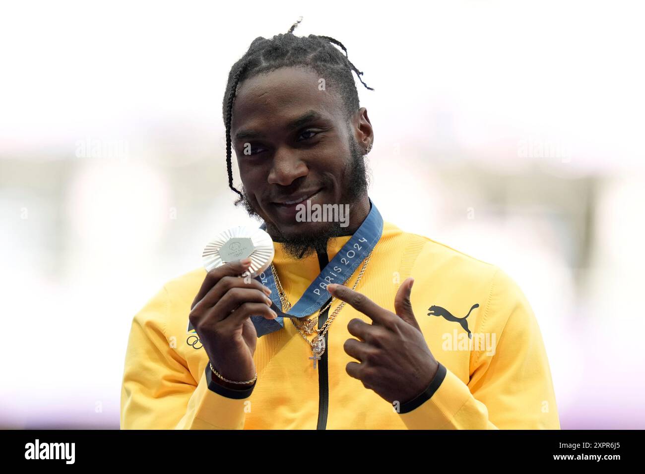 Men's long jump silver medalist, Wayne Pinnock, of Jamaica, points to ...