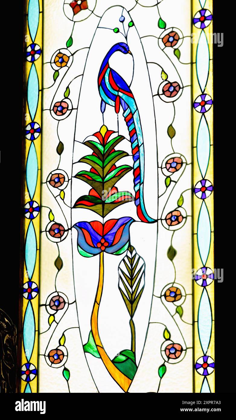 Stained glass window with peacock and flowers in the interior of the ...