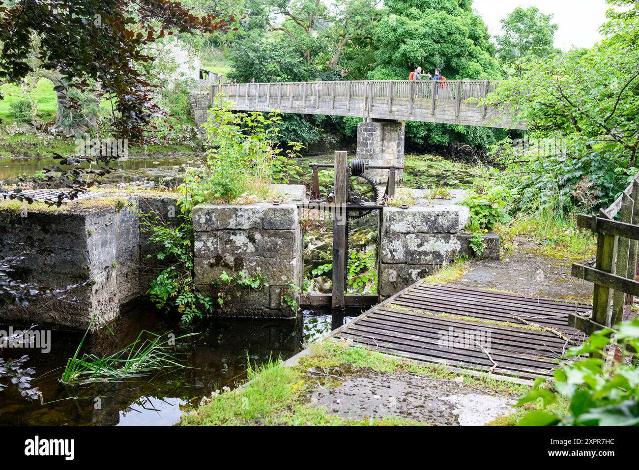 Grassington Yorkshire UK-27 July 2024. Historic wooden bridge over a ...
