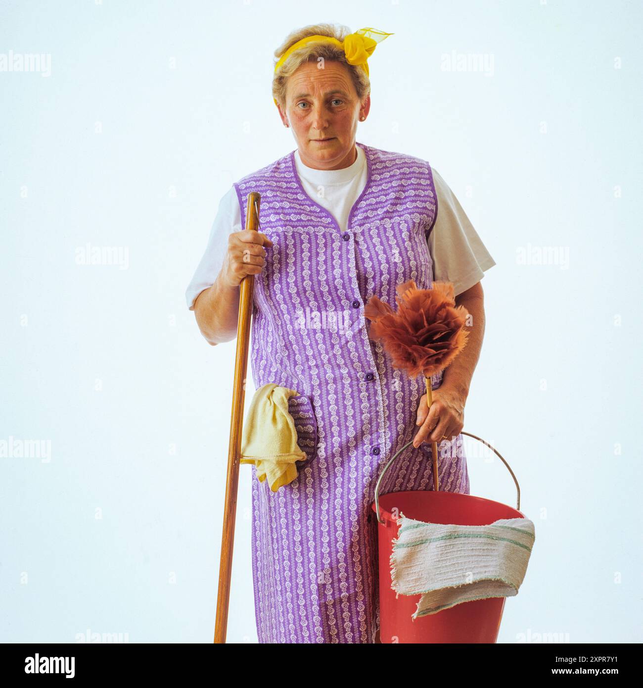 Serious senior woman cleaner with cleaning equipment Stock Photo - Alamy