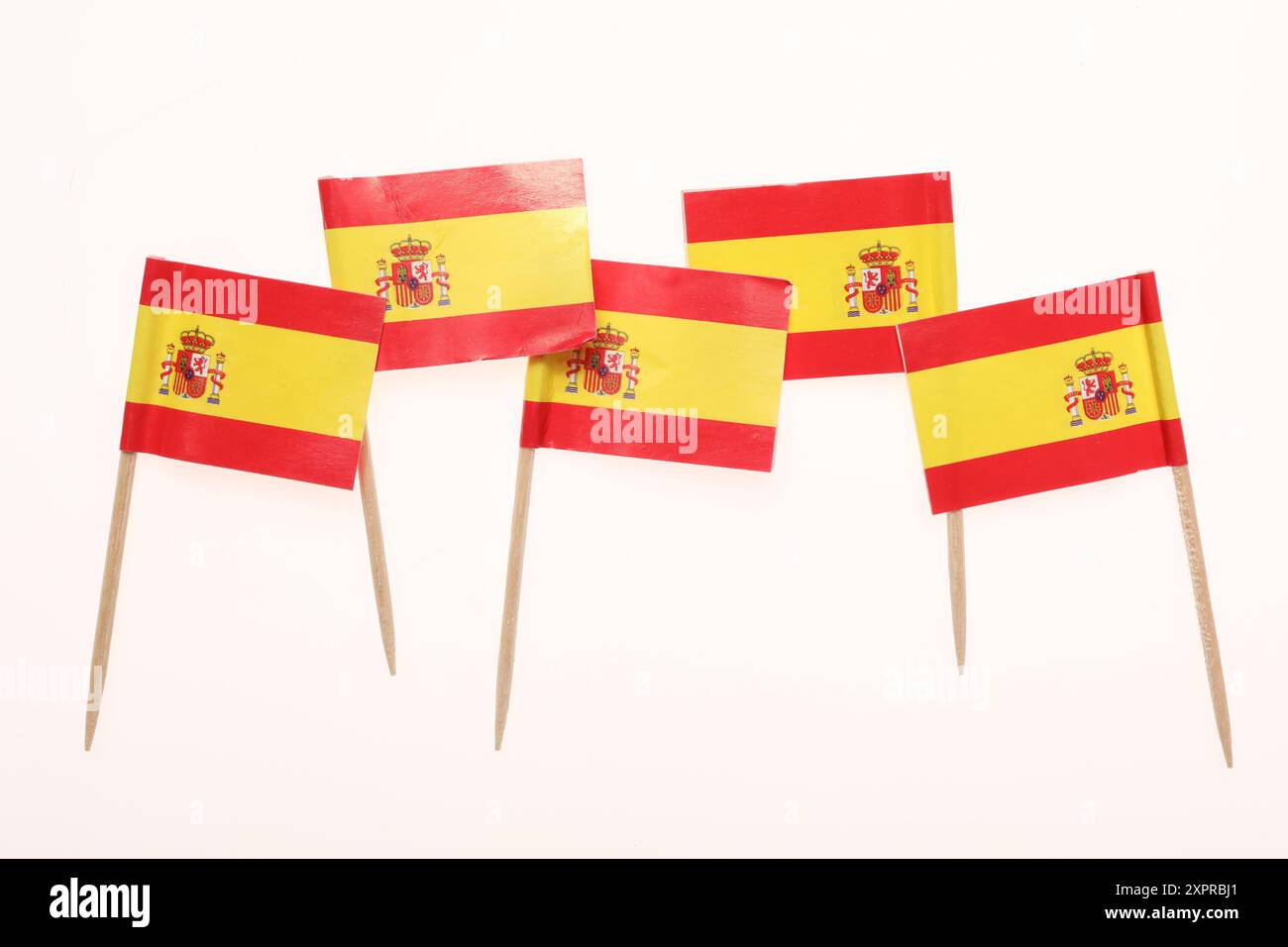 Small paper flags of Spain isolated on white Stock Photo - Alamy