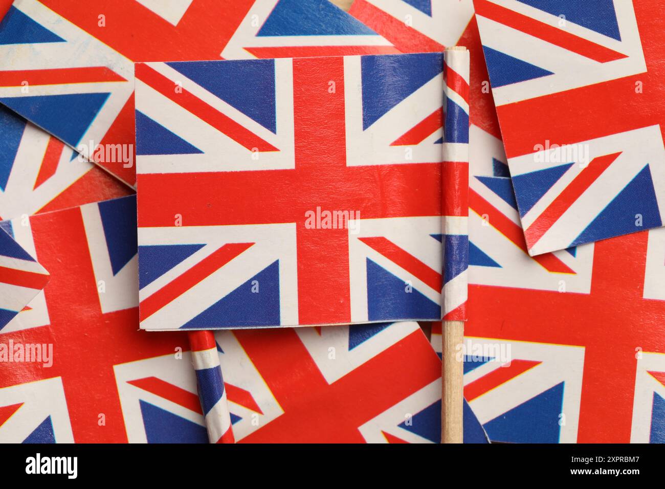 Small paper flags of United Kingdom as background, top view Stock Photo ...