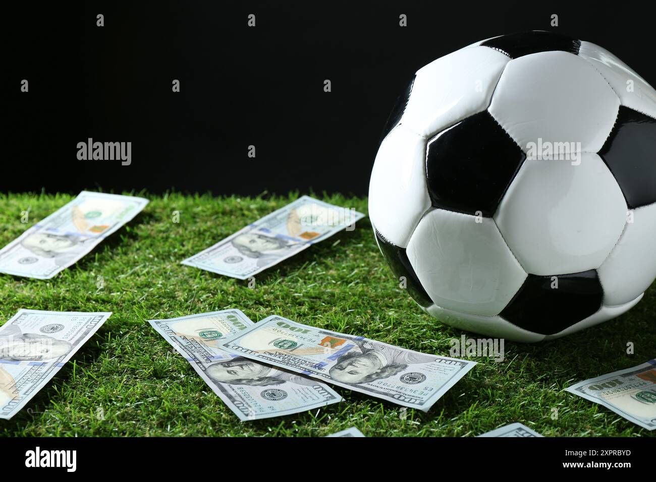 Soccer ball and dollar banknotes on green grass Stock Photo - Alamy