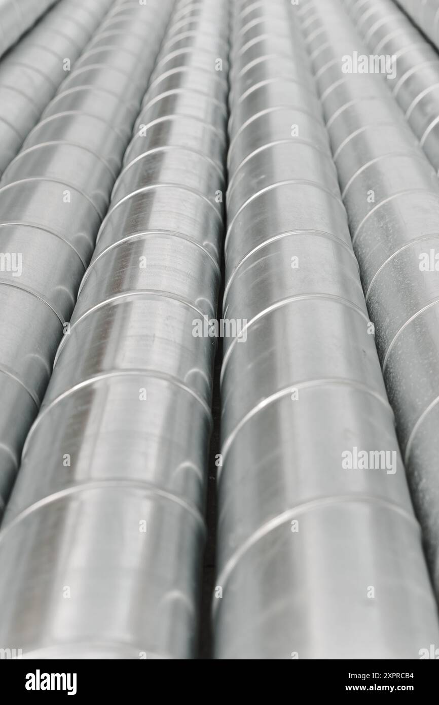 Ventilation duct pipes made of rolled steel in a warehouse, storage at ...