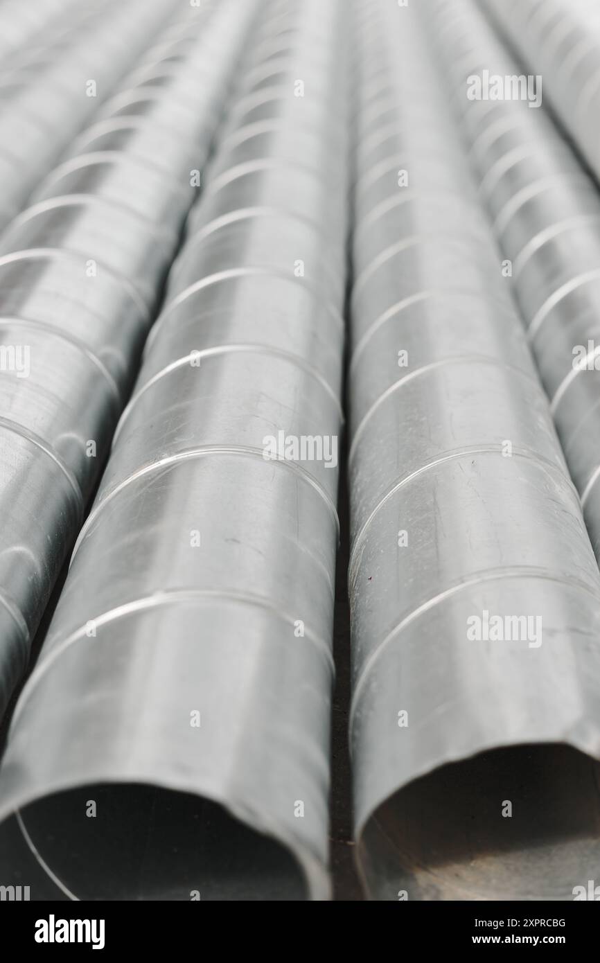 Ventilation duct pipes made of rolled steel in a warehouse, storage at ...