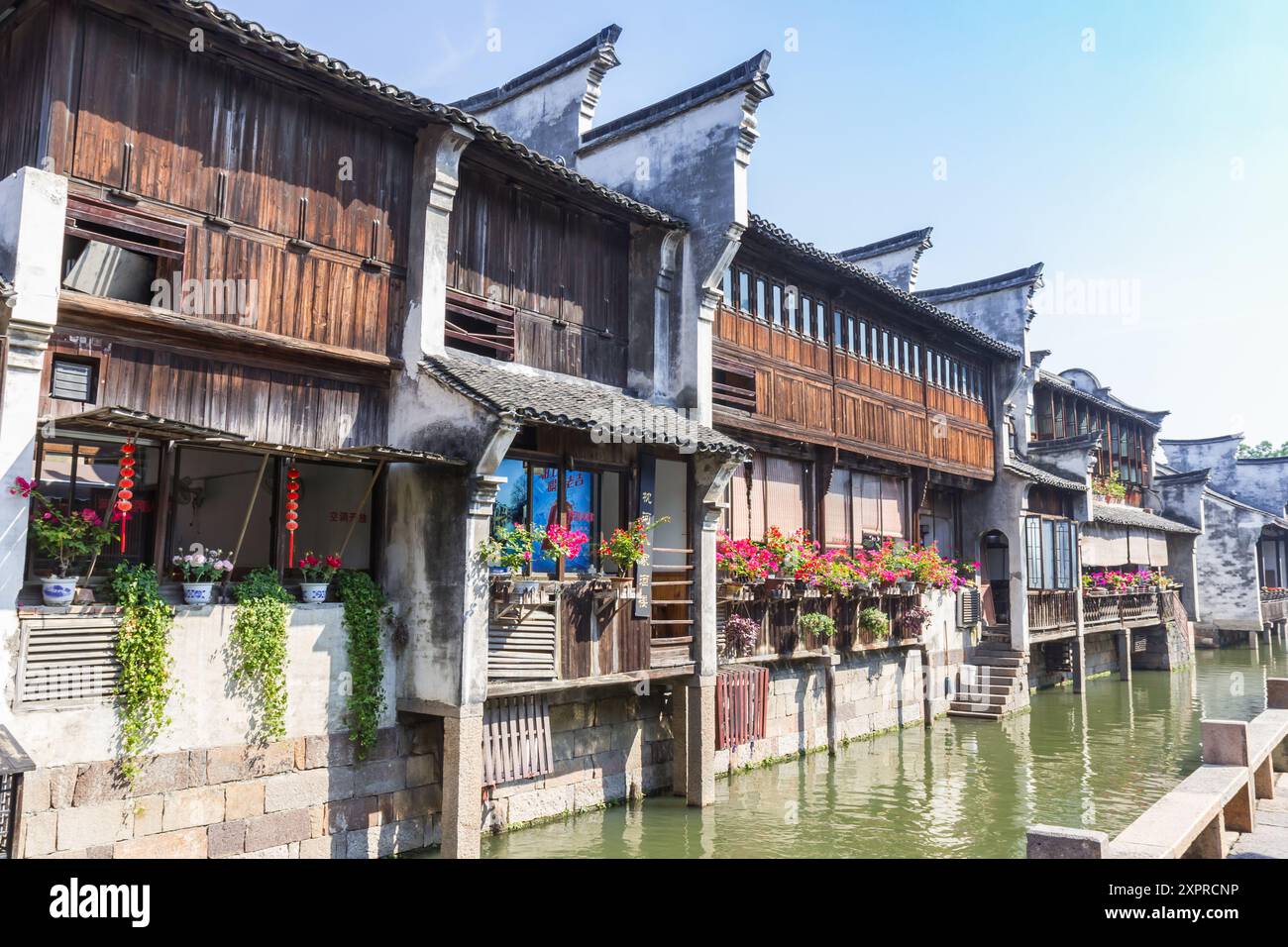 Balconies with flowers at the canal in Wuzhen, China Stock Photo - Alamy