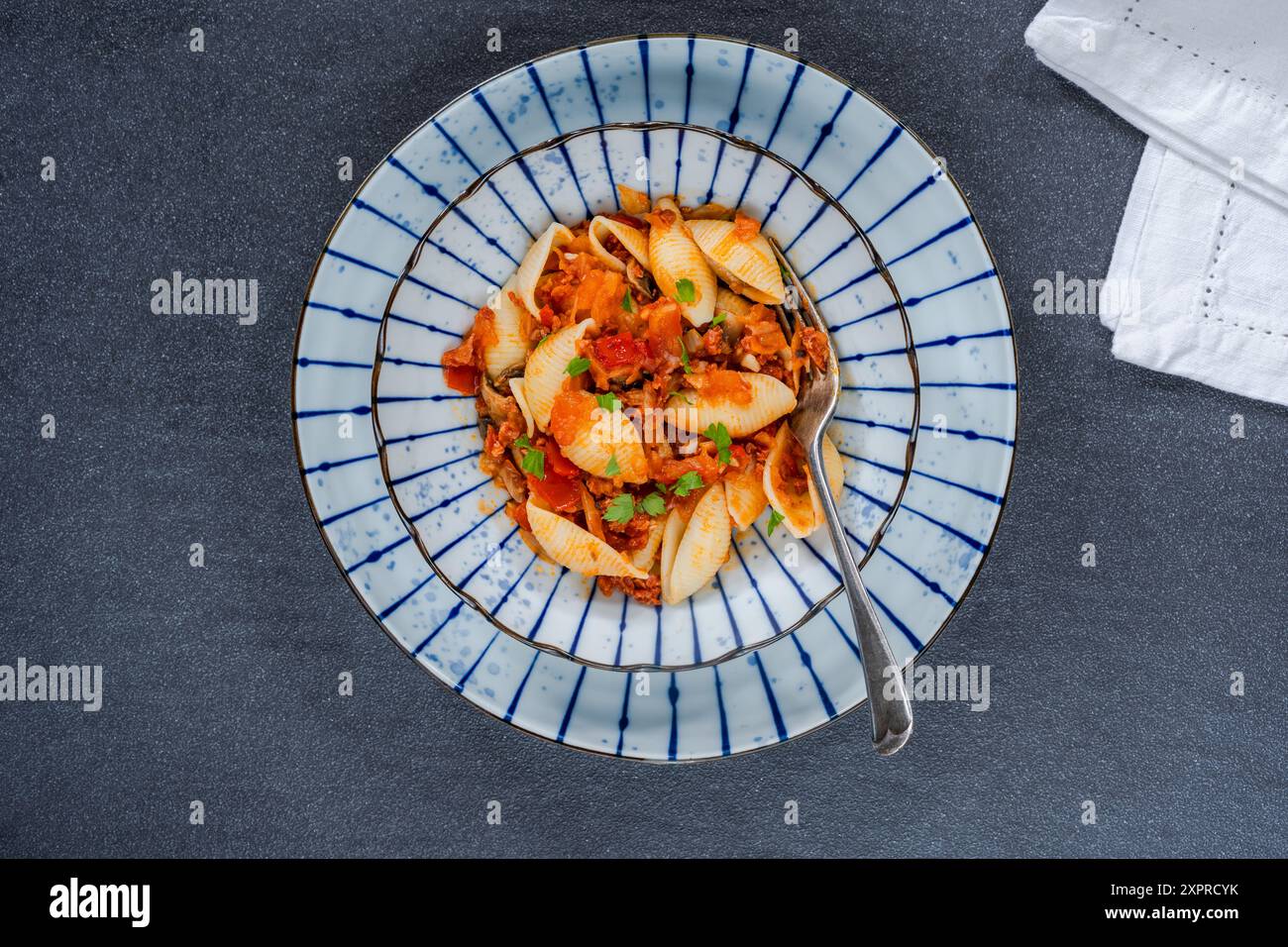Pasta shells with tomato, mushrooms and chorizo sauce Stock Photo - Alamy