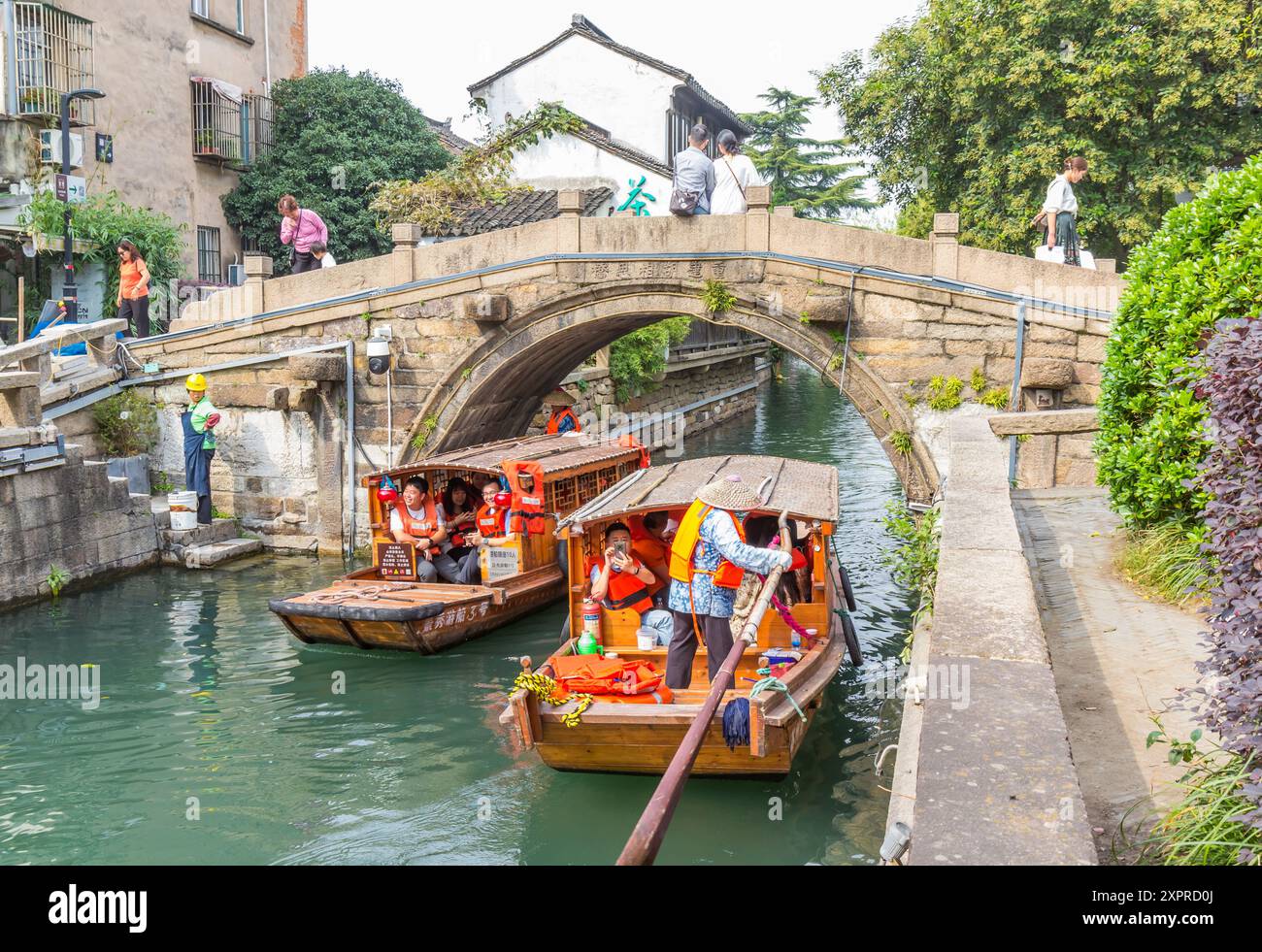 Traditional wooden boats under the historic bridge in Suzhou, China ...