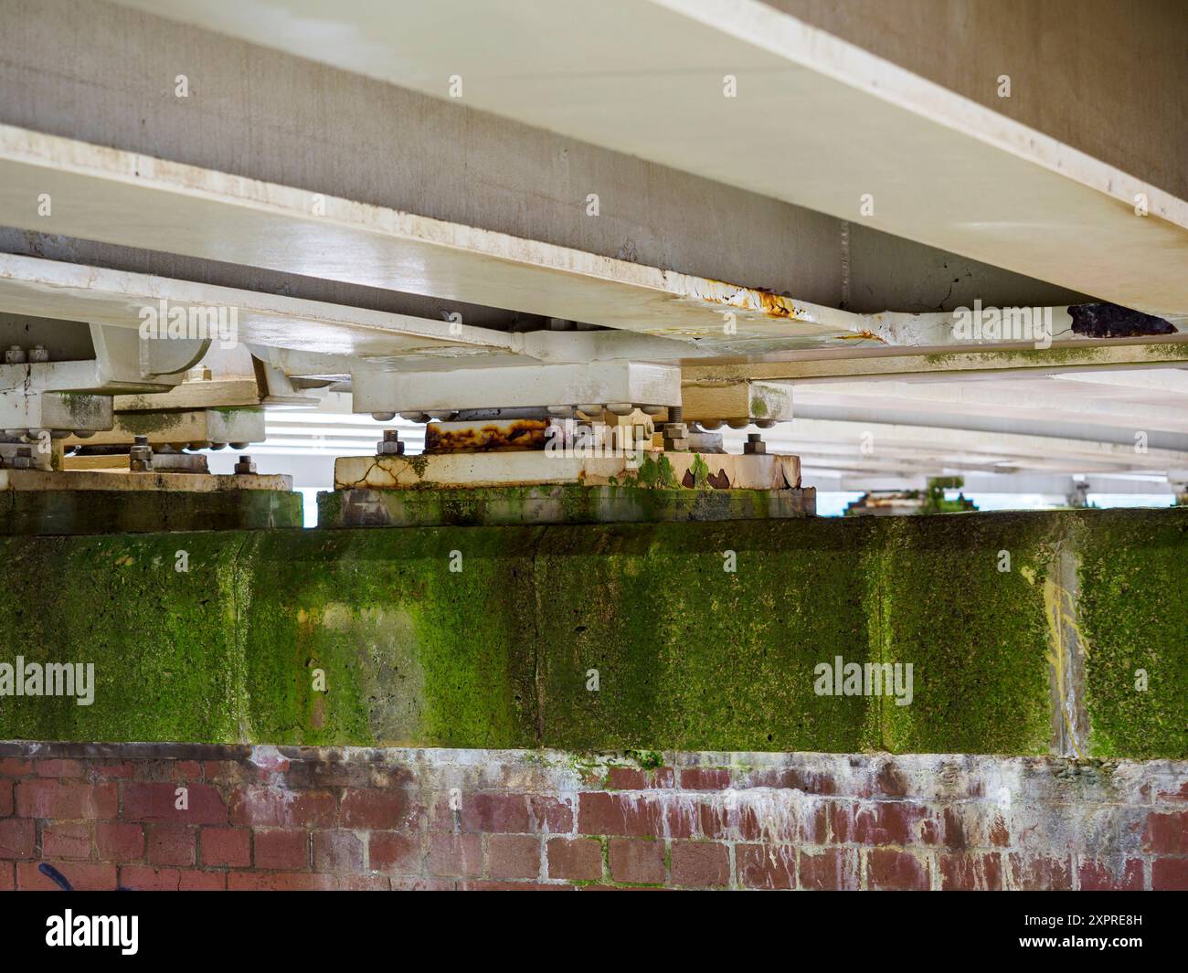 Close-up view of the understructure of a bridge showing steel beams ...