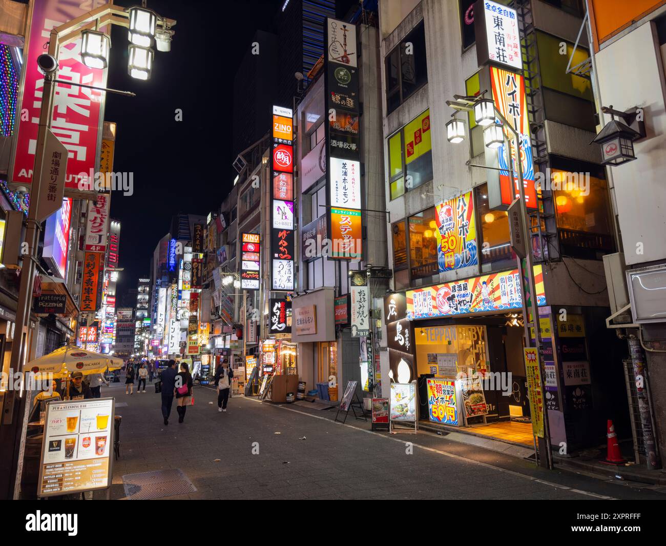 Shops and restaurants at night on Kabukicho Ichiban Gai Street in ...