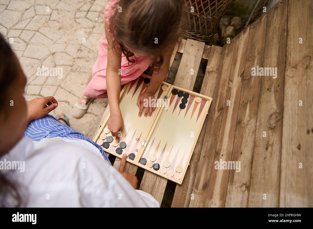 Mother and daughter enjoying quality time by playing backgammon ...