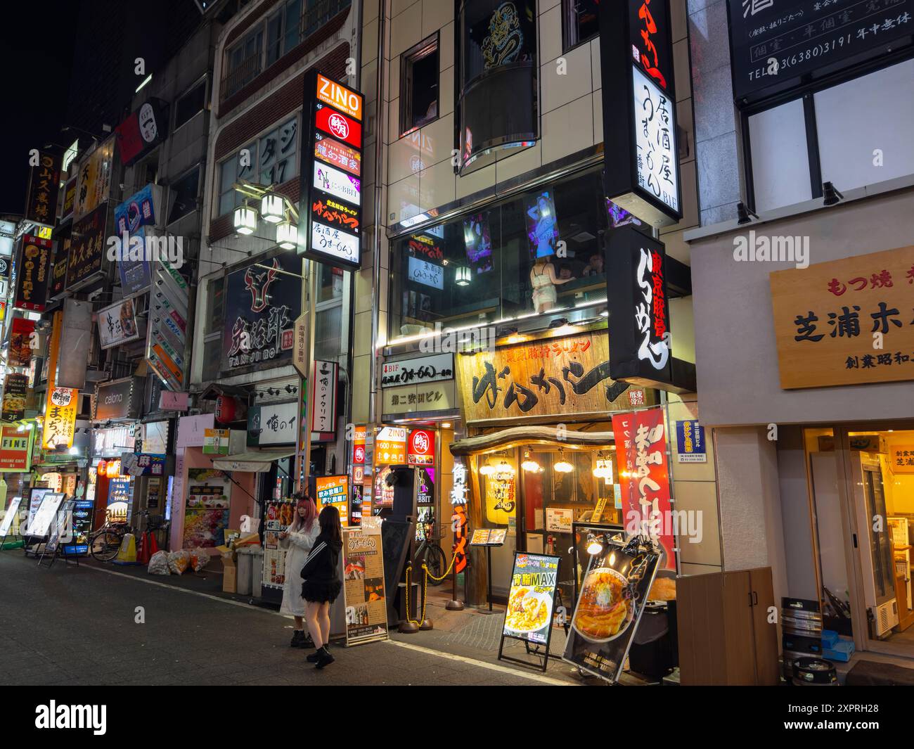 Shops and restaurants at night on Kabukicho Ichiban Gai Street in ...