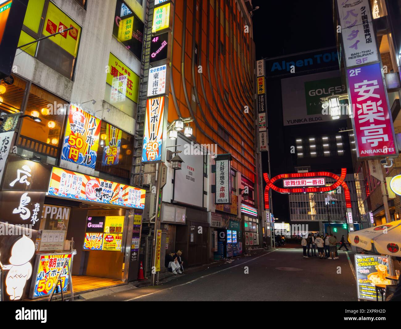 Shops and restaurants at night on Kabukicho Ichiban Gai Street in ...