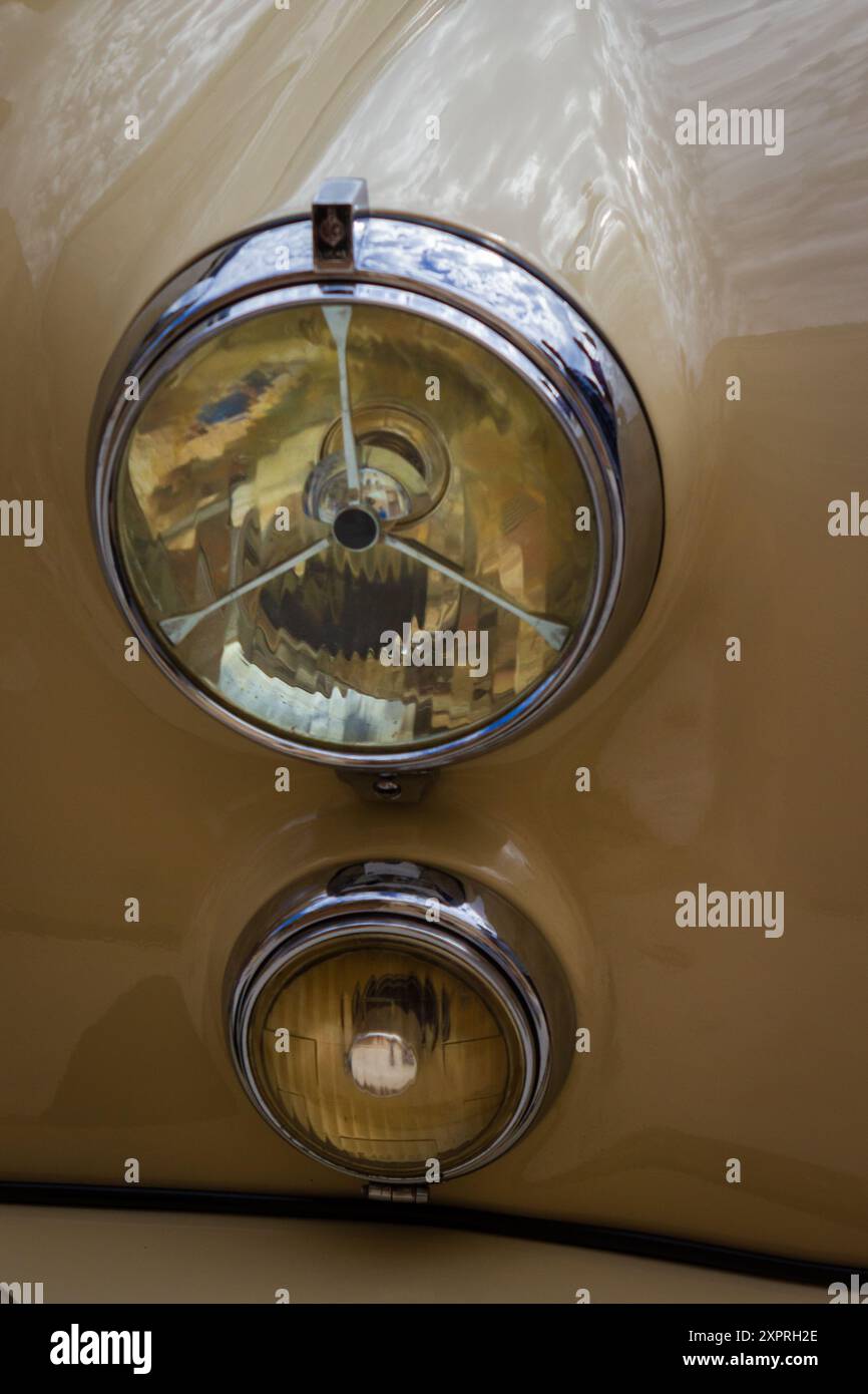 Shiny, old-fashioned car headlight with elegant chrome and metal ...