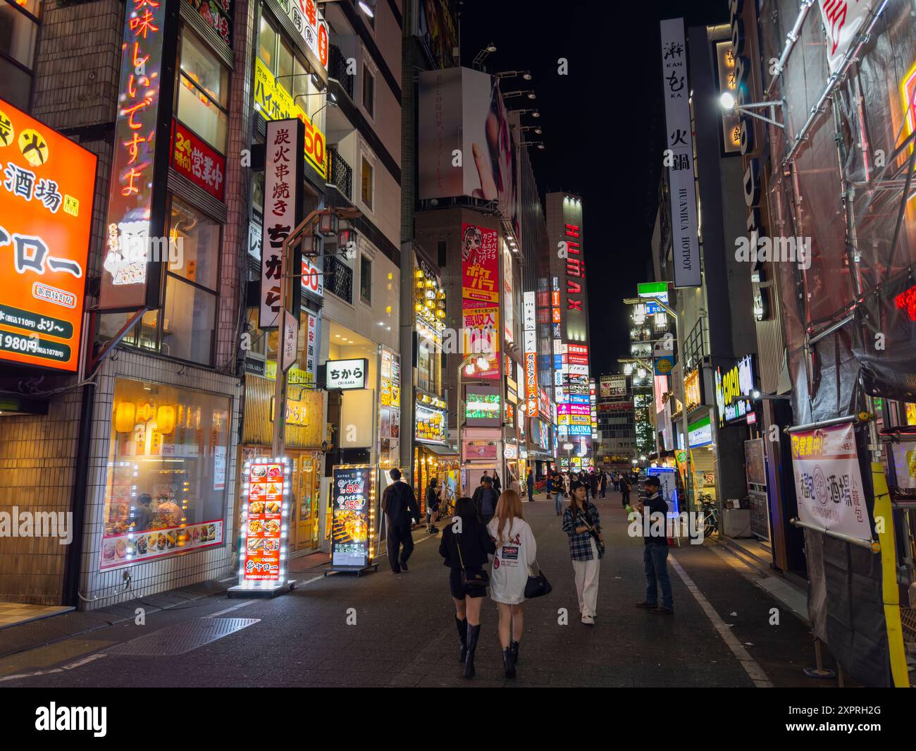 Shops and restaurants at night on Kabukicho Ichiban Gai Street in ...