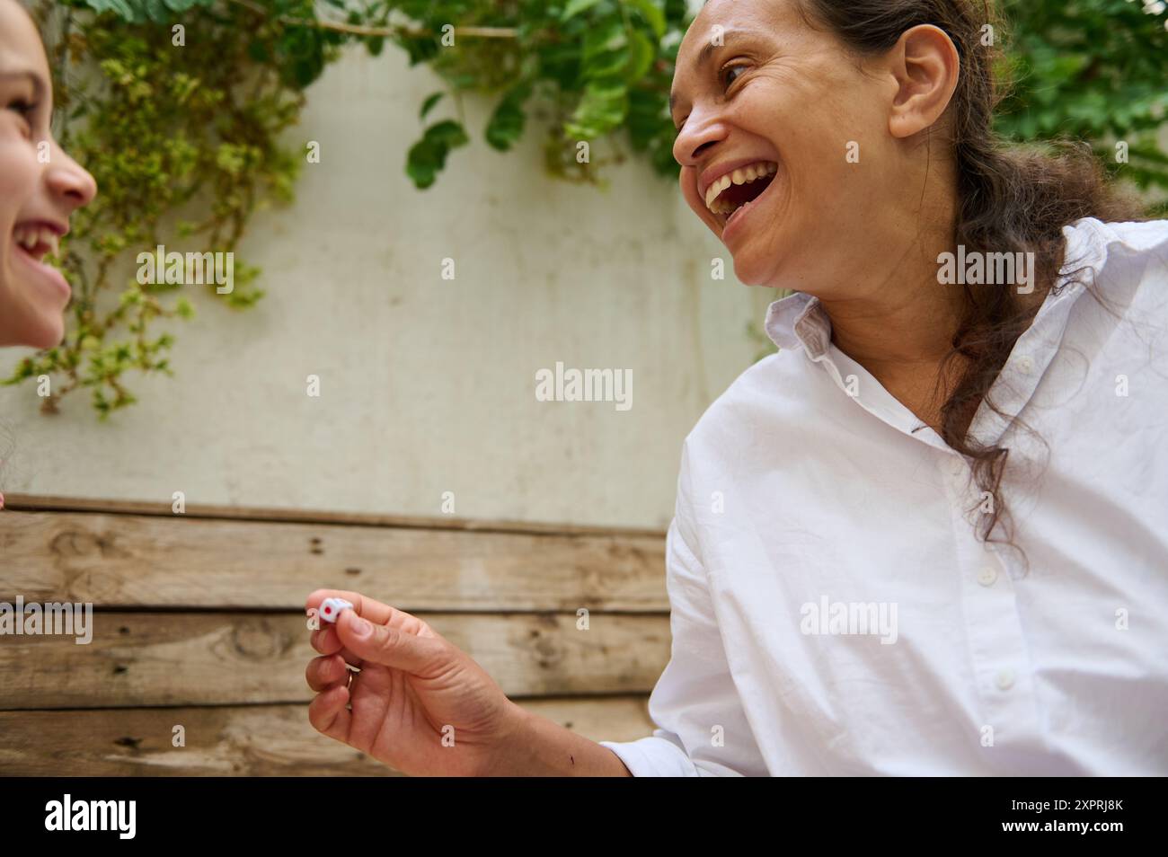 A joyful moment captured between a mother and daughter, sharing ...