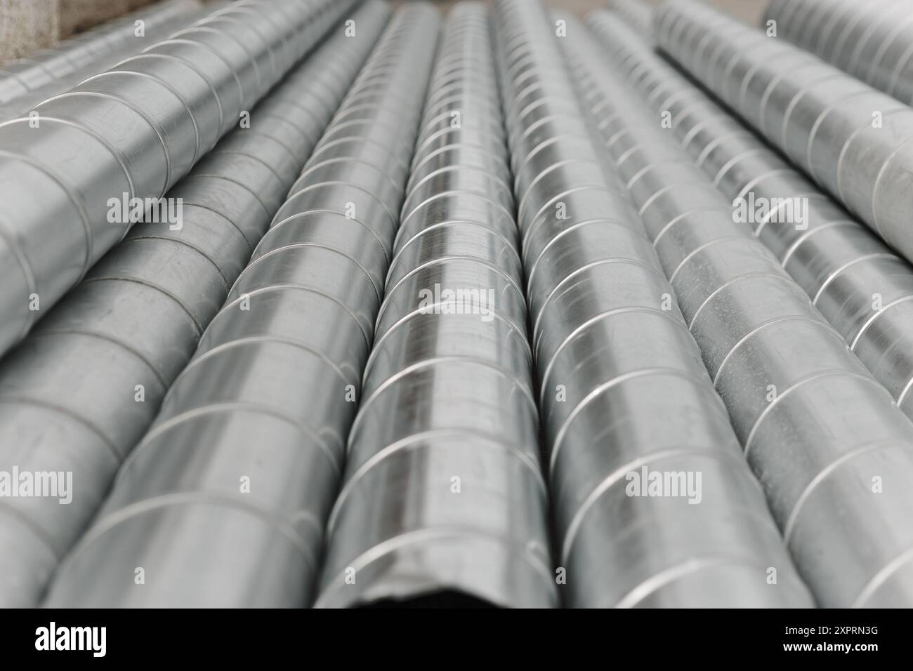 Ventilation duct pipes made of rolled steel in a warehouse, storage at ...