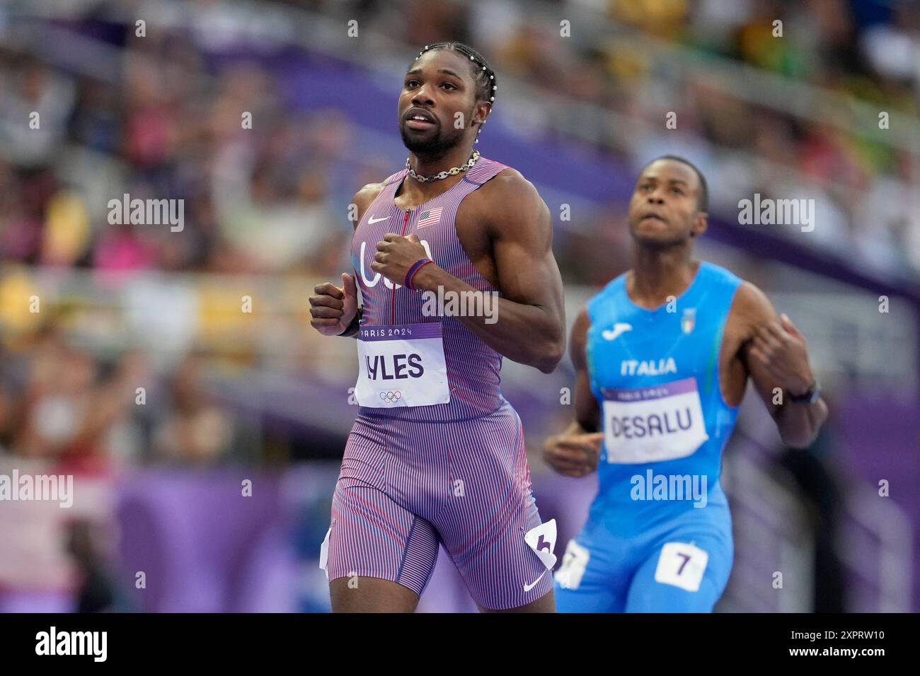 Noah Lyles, of the United States, crosses the finish line to qualify in ...