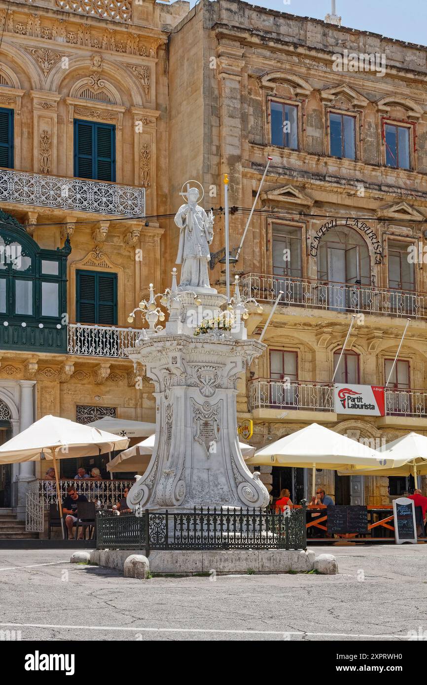 St. Lawrence statue; 16 century; large pedastal; flowers, lights ...