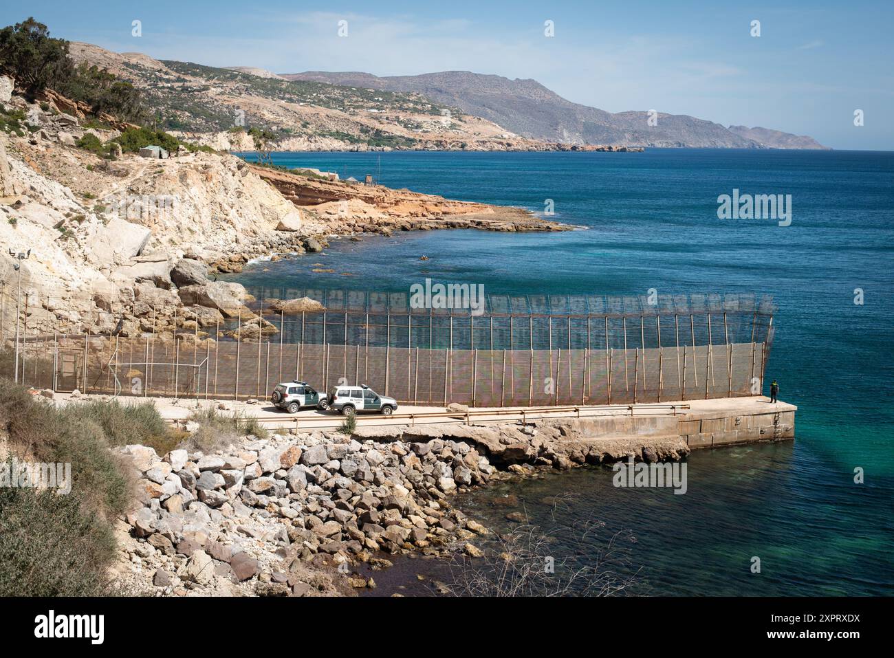 Guardia Civil officers using patrol cars to monitor the perimeter fence ...