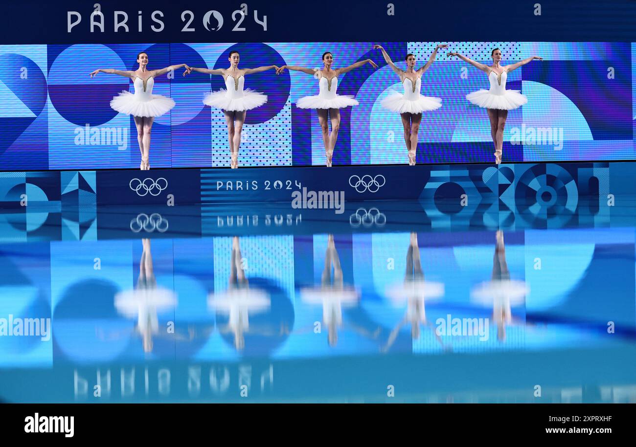 Performers dance by the pool before the start of the artistic swimming ...