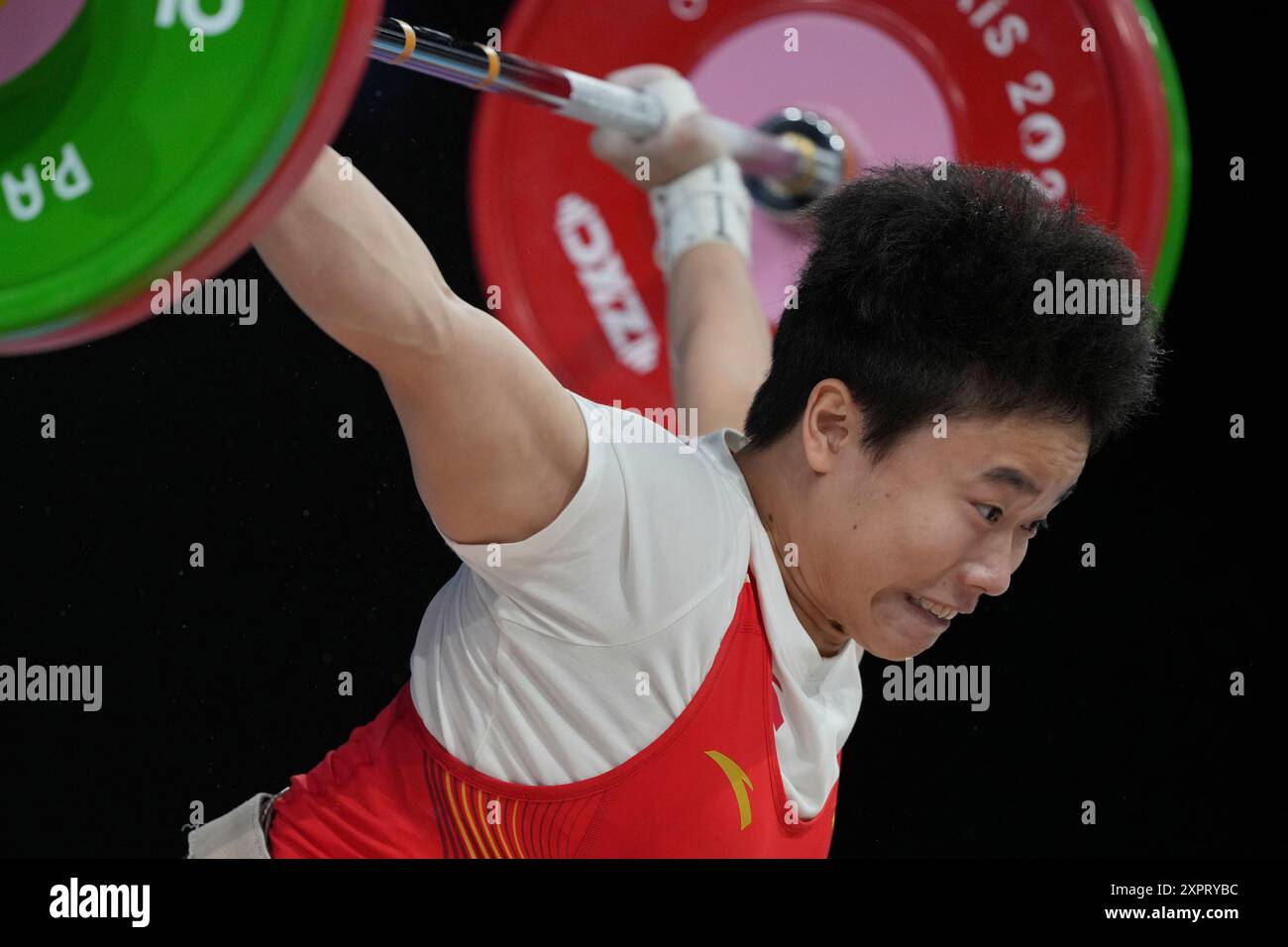 Hou Zhihui of China competes during the women's 49kg weightlifting ...