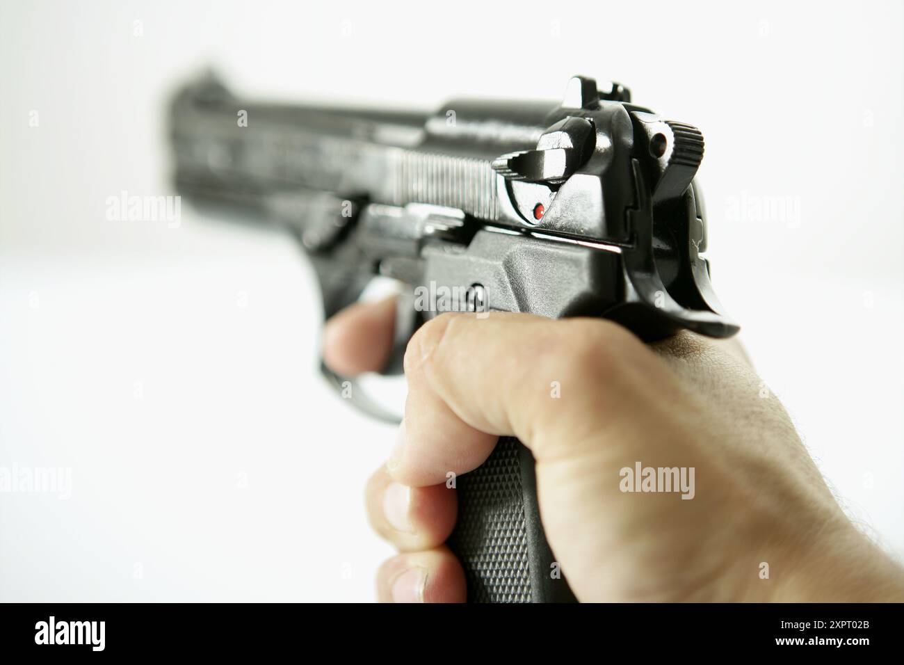 Aiming pistol in a hand Stock Photo - Alamy