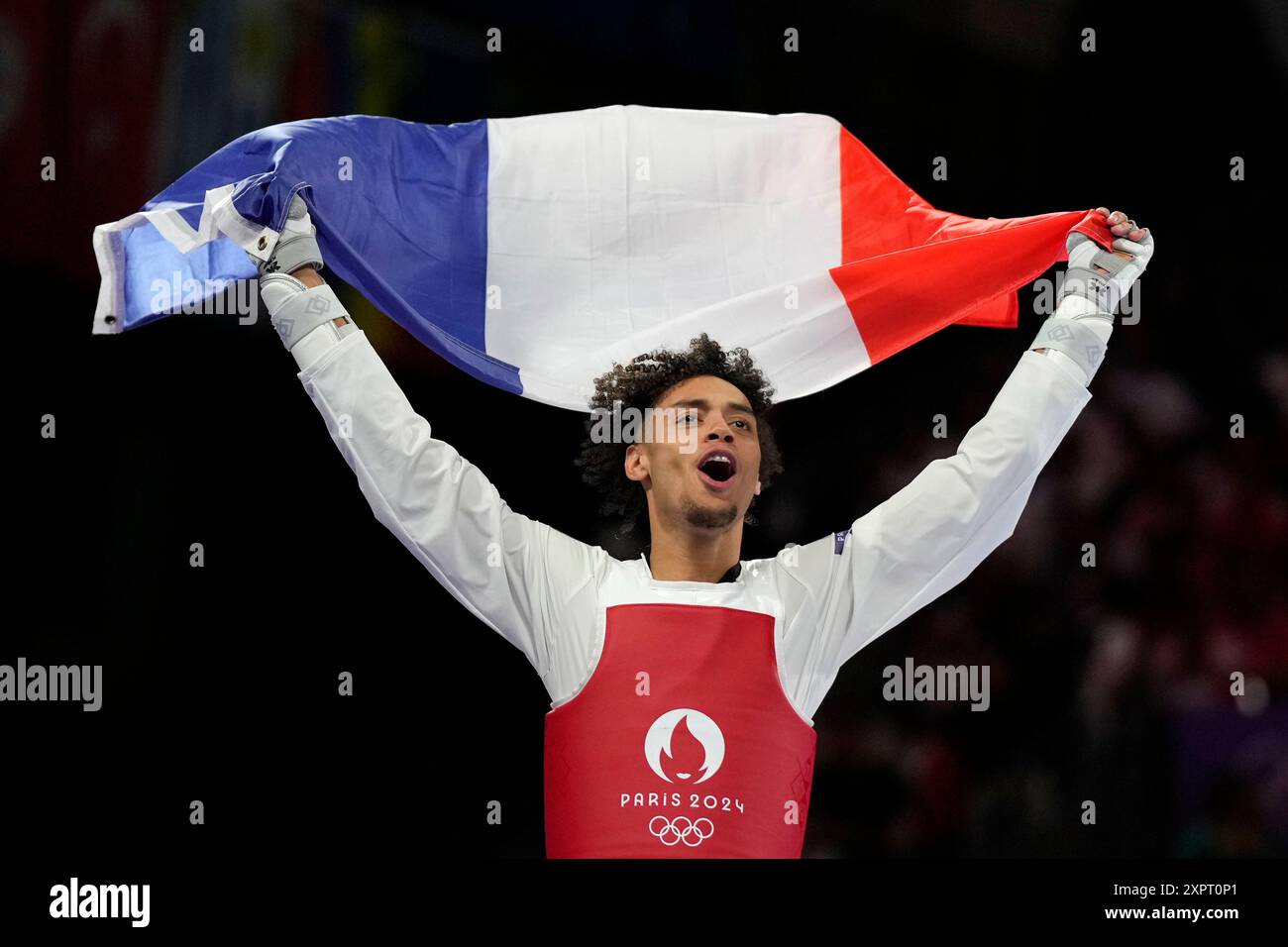 France's Cyrian Ravet celebrates after winning the men's 58kg Taekwondo ...