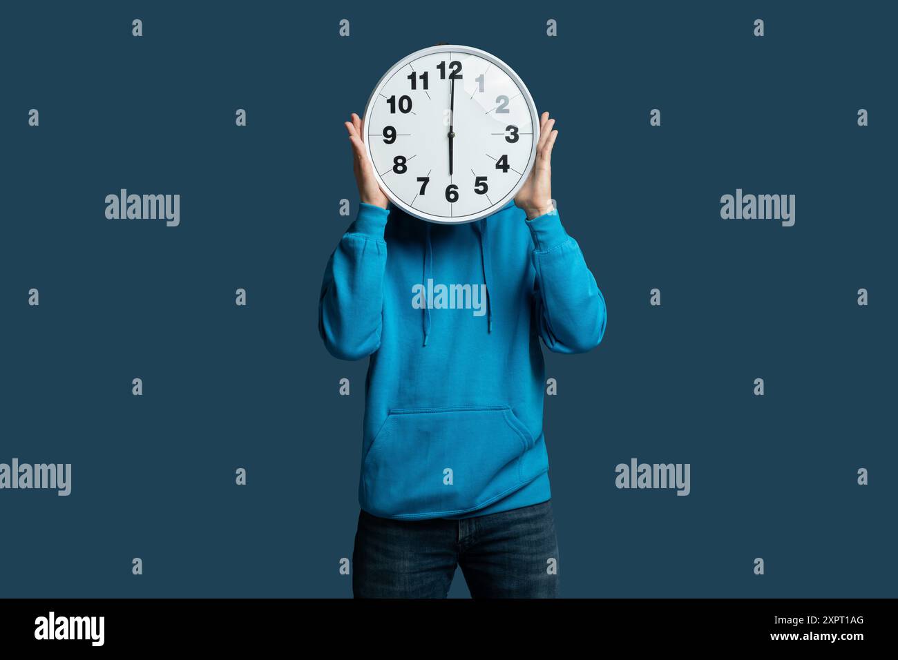 Young Person Holding Large Wall Clock in Front of Face Stock Photo - Alamy