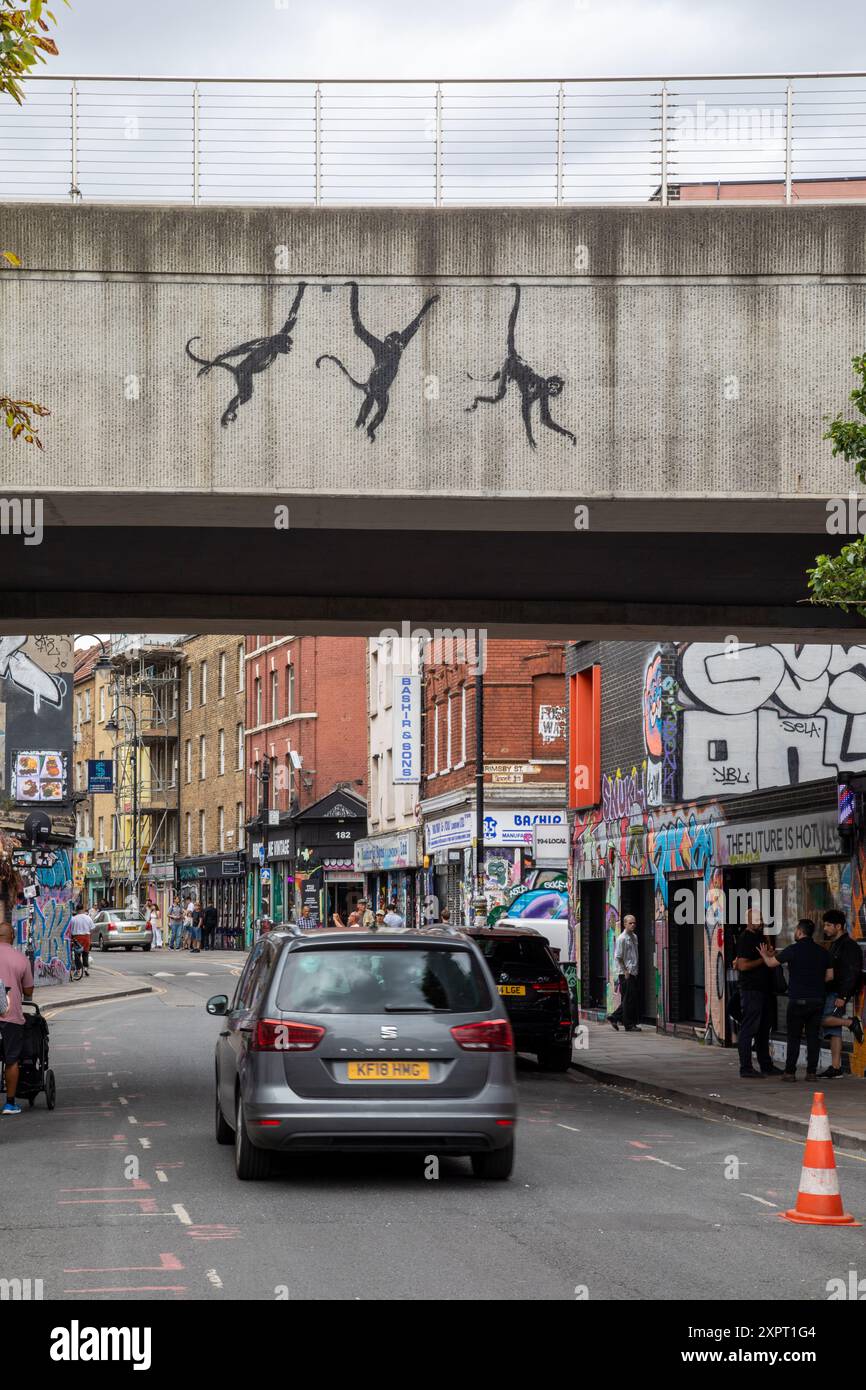 Banksy's three monkeys on the bridge at junction of Brick Lane East ...