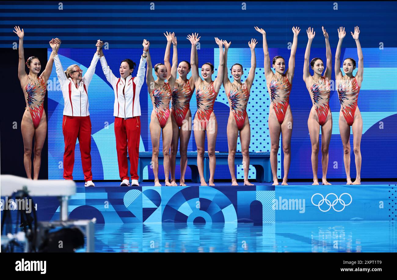 Members of the China team wave their hands after performing an artistic ...