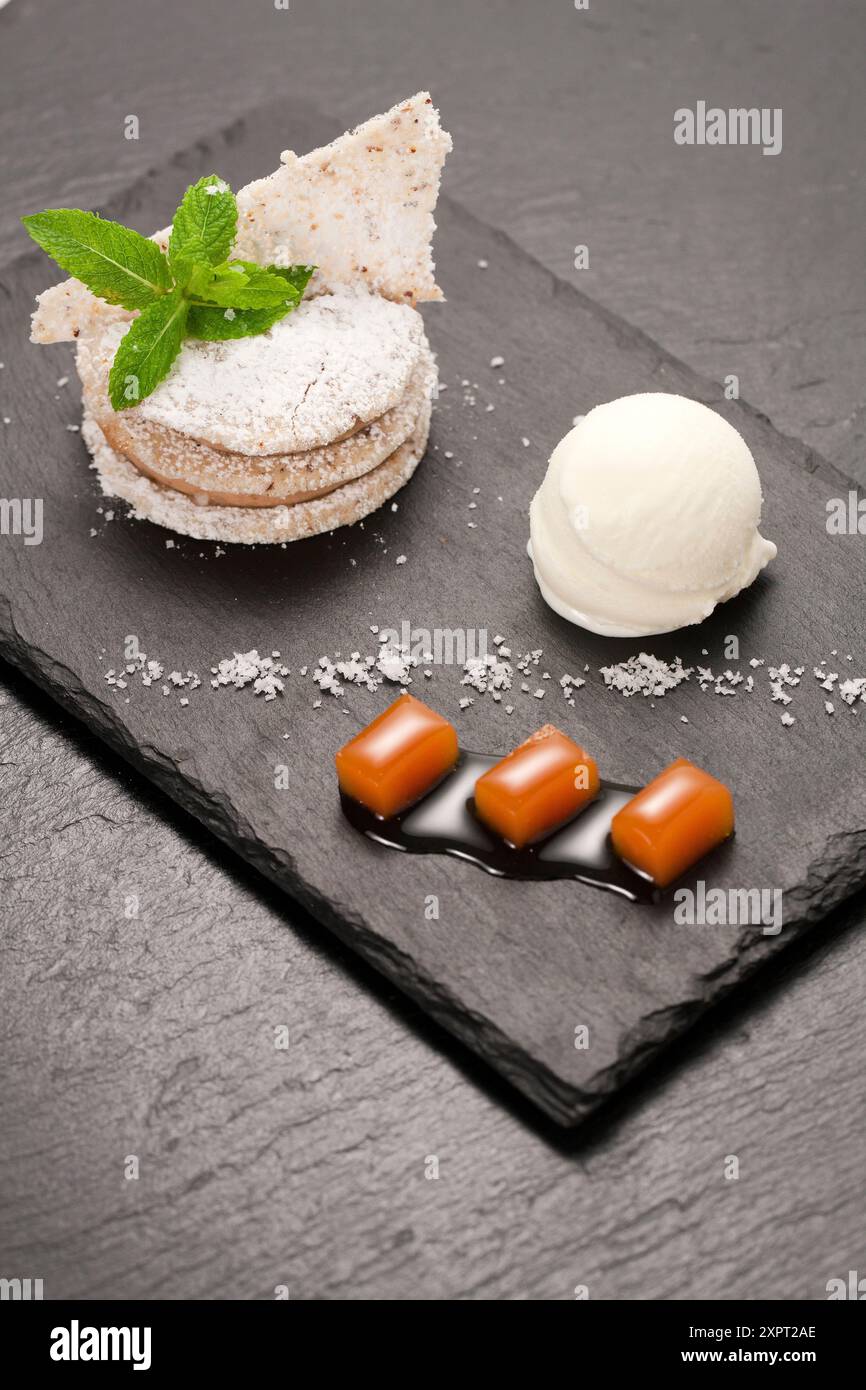 Nougat mousse with fleur de sel and passion fruit cubes Stock Photo - Alamy